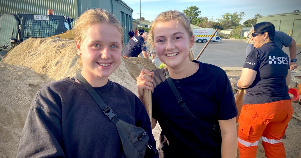 The sandbagging has begun with locals and backpackers pitching in ...